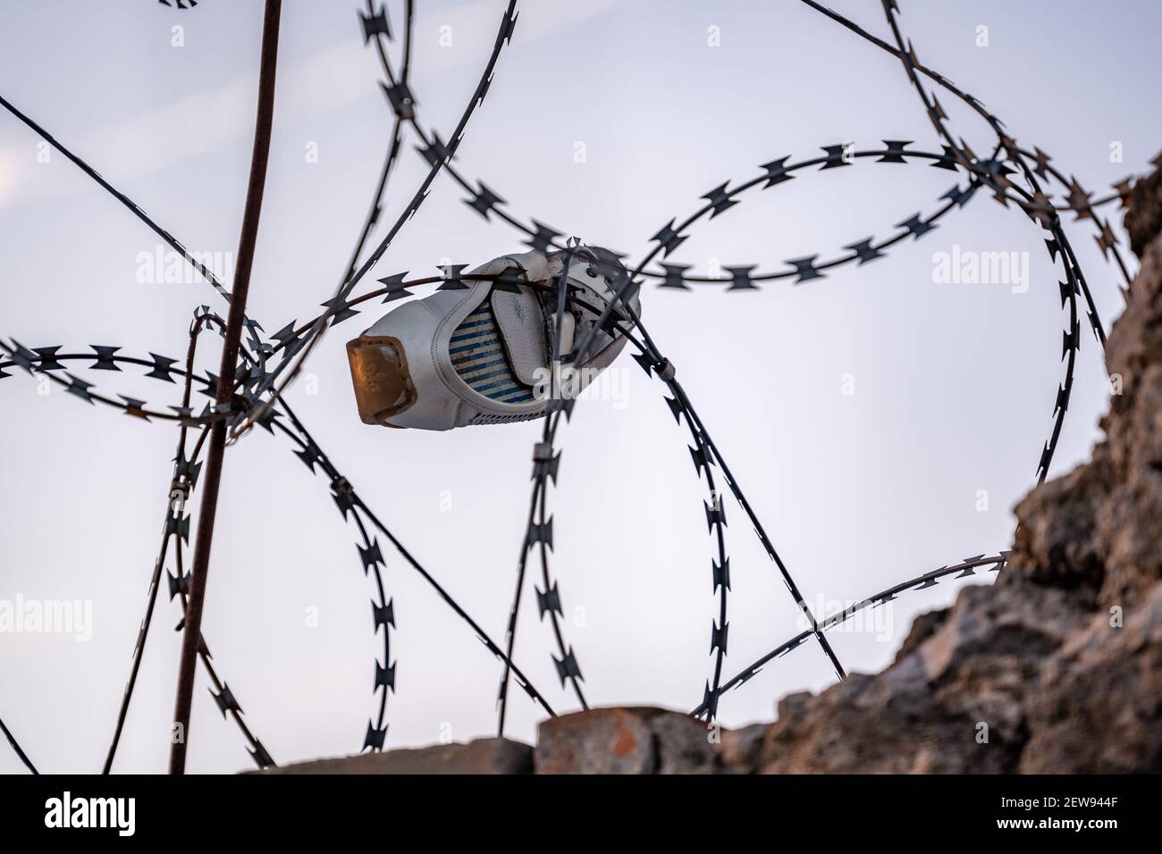 close up of shoe in barbed wire fence Stock Photo - Alamy
