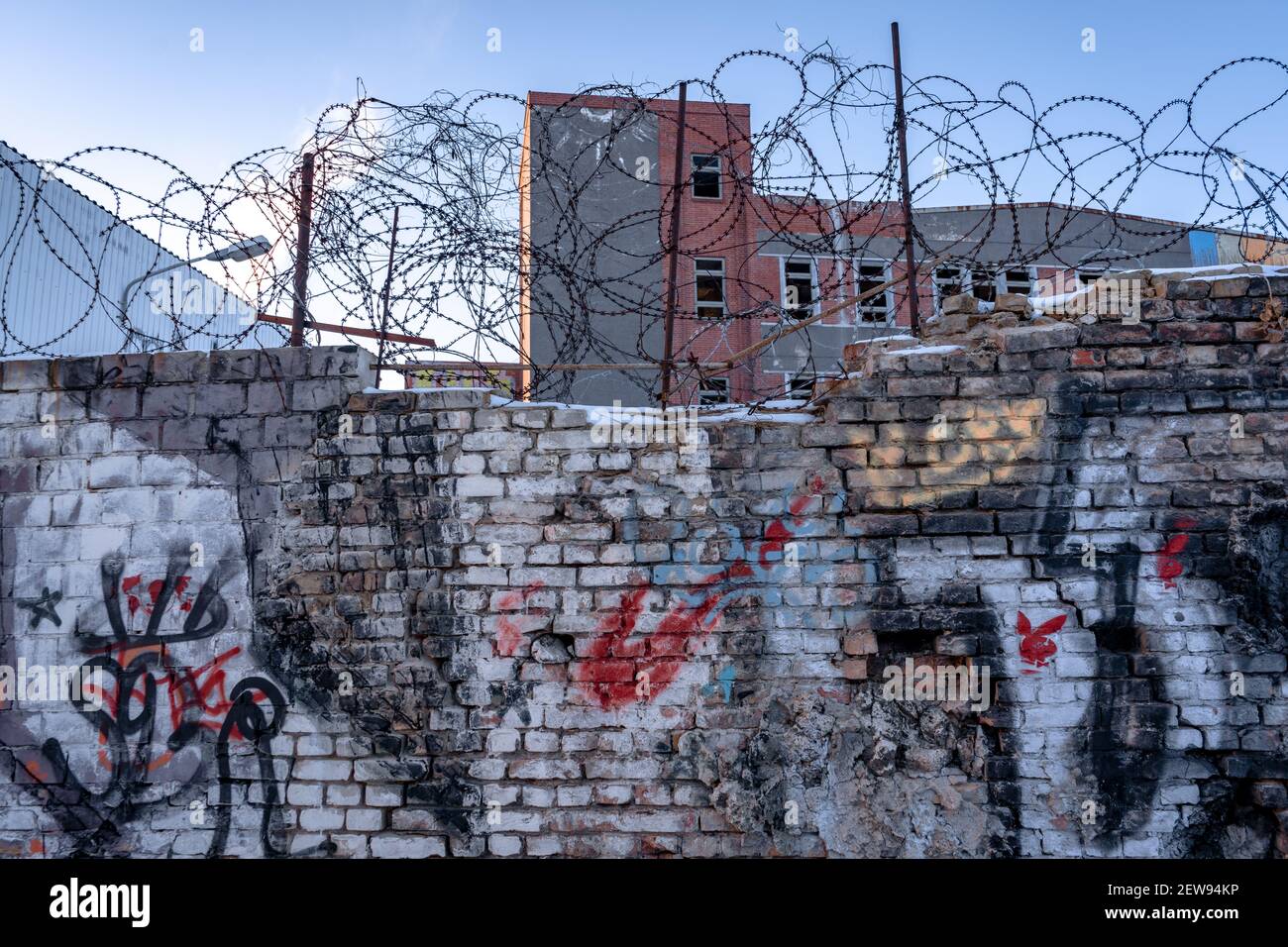 building with graffiti wall and barbed wire Stock Photo - Alamy
