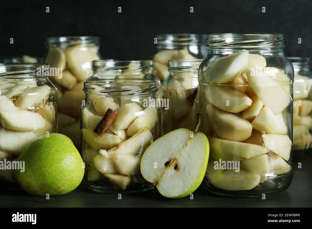 A closeup shot of glass transparent bottle jars filled with ripe peeled ...