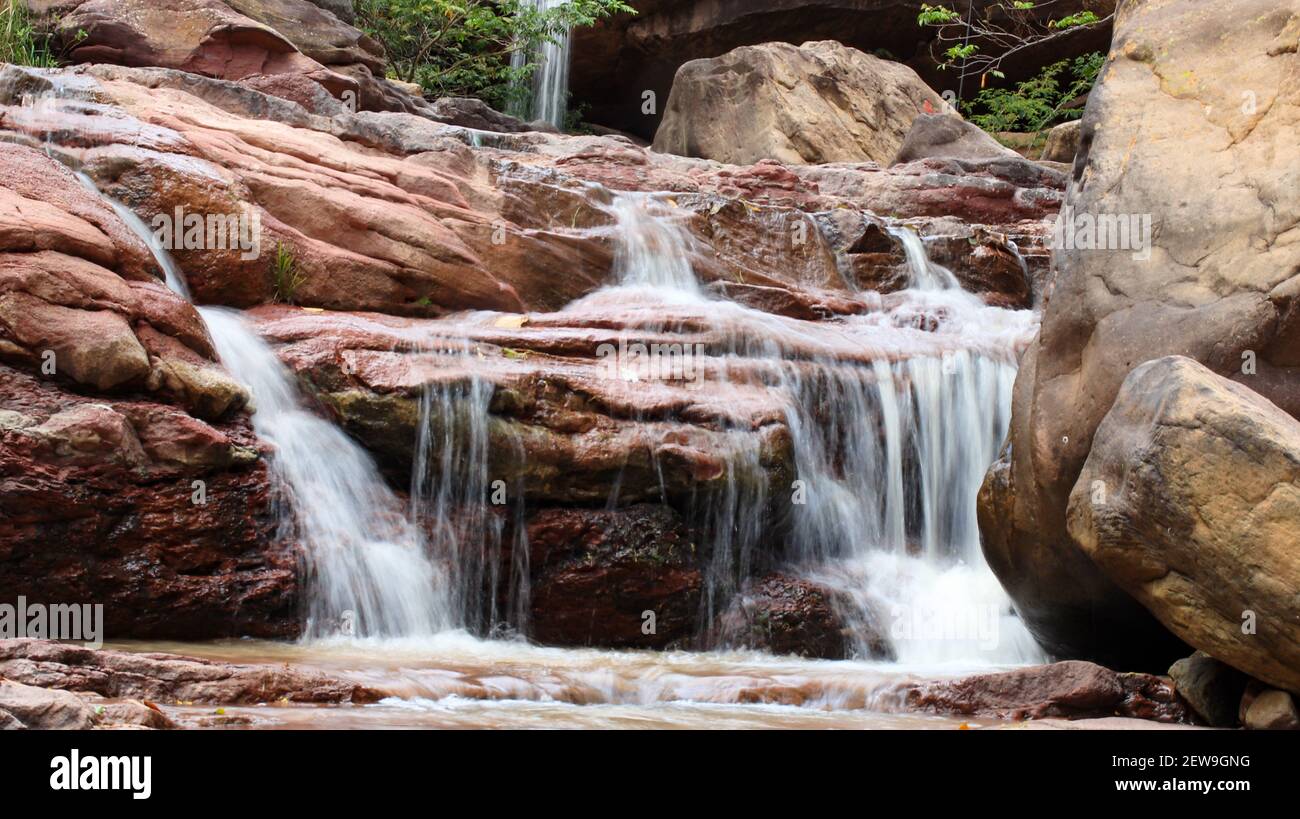 A beautiful small waterfall during the daytime Stock Photo - Alamy