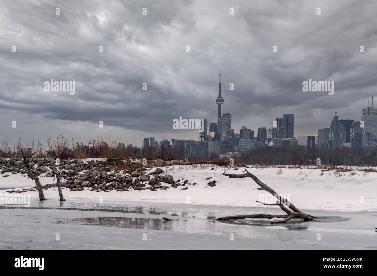 Beautiful cityscape of Toronto under a stormy sky with a frozen lake in ...
