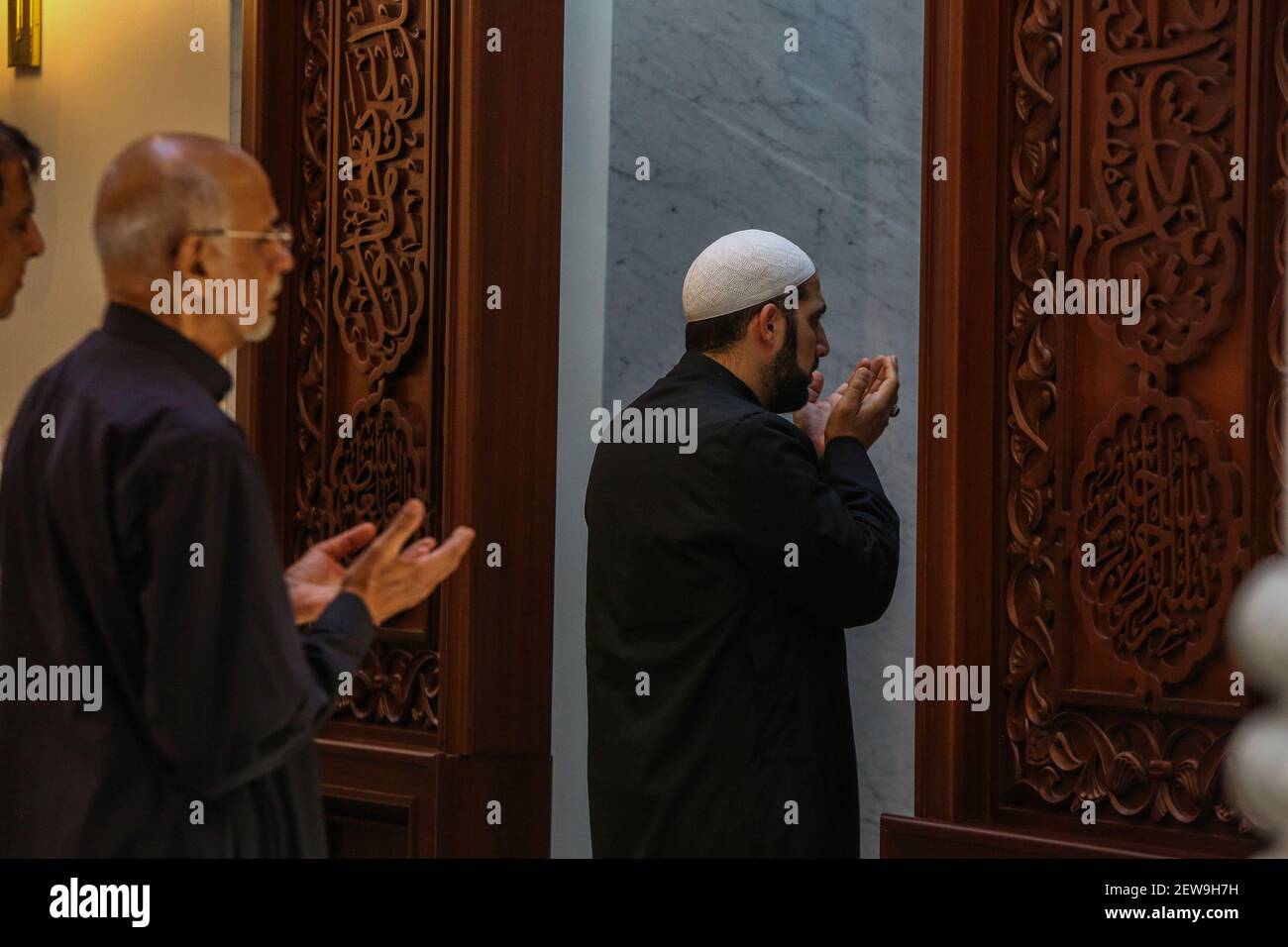 Imam Mujtaba Khaliq leads midday prayers on Nov. 1, 2017. Various ...