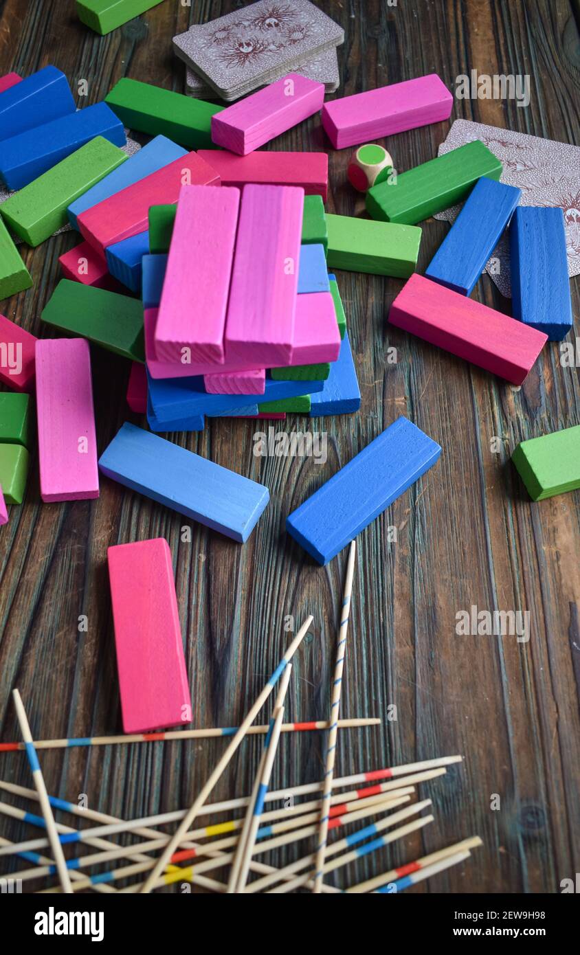A high angle view of playing cards, rectangular colorful wooden blocks ...