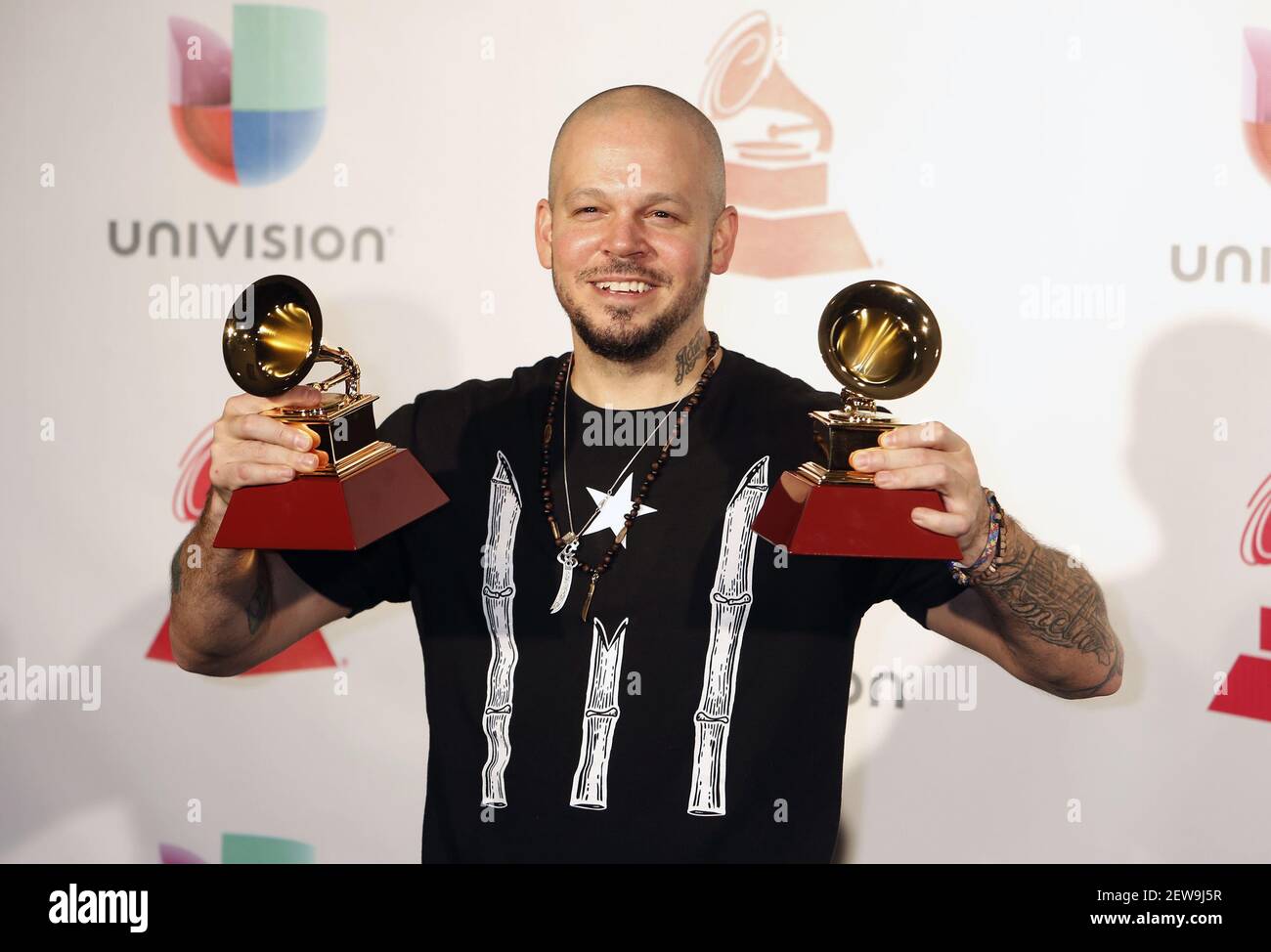 Residente poses in the press room with the award for best urban music ...