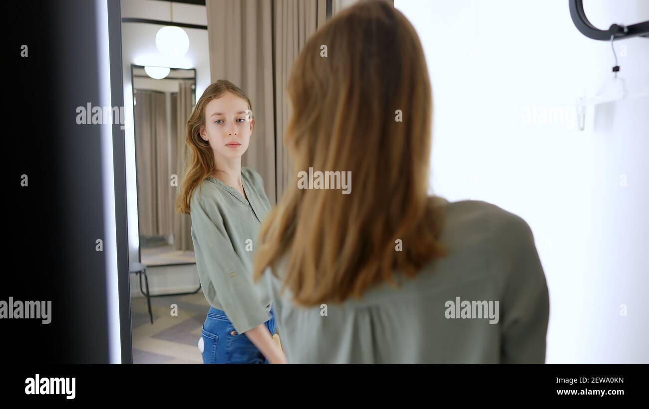 Tween girl standing in fitting room in clothing store Stock Photo - Alamy