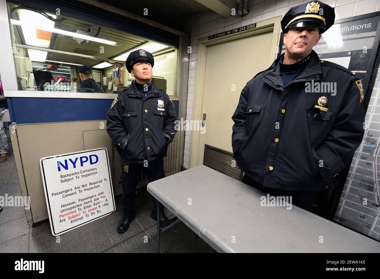NYPD officers stand at a security bag check point in the 81st MTA ...