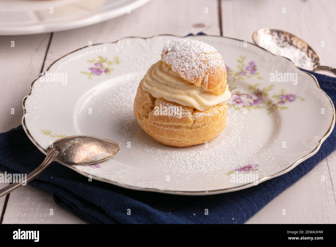 Vanilla cream puffs, for a snack, on a wooden table Stock Photo - Alamy