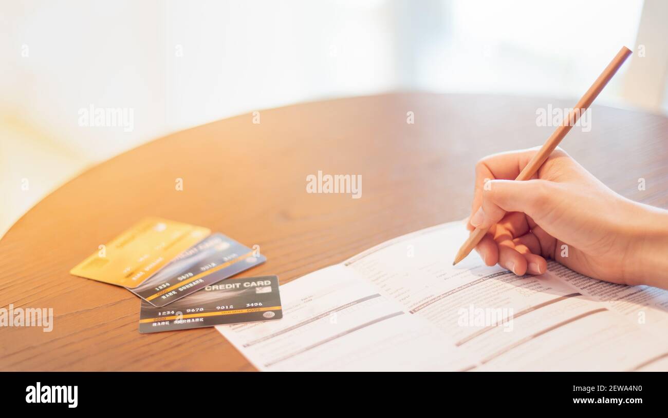 The female hand writing on the Blank credit application form for ...