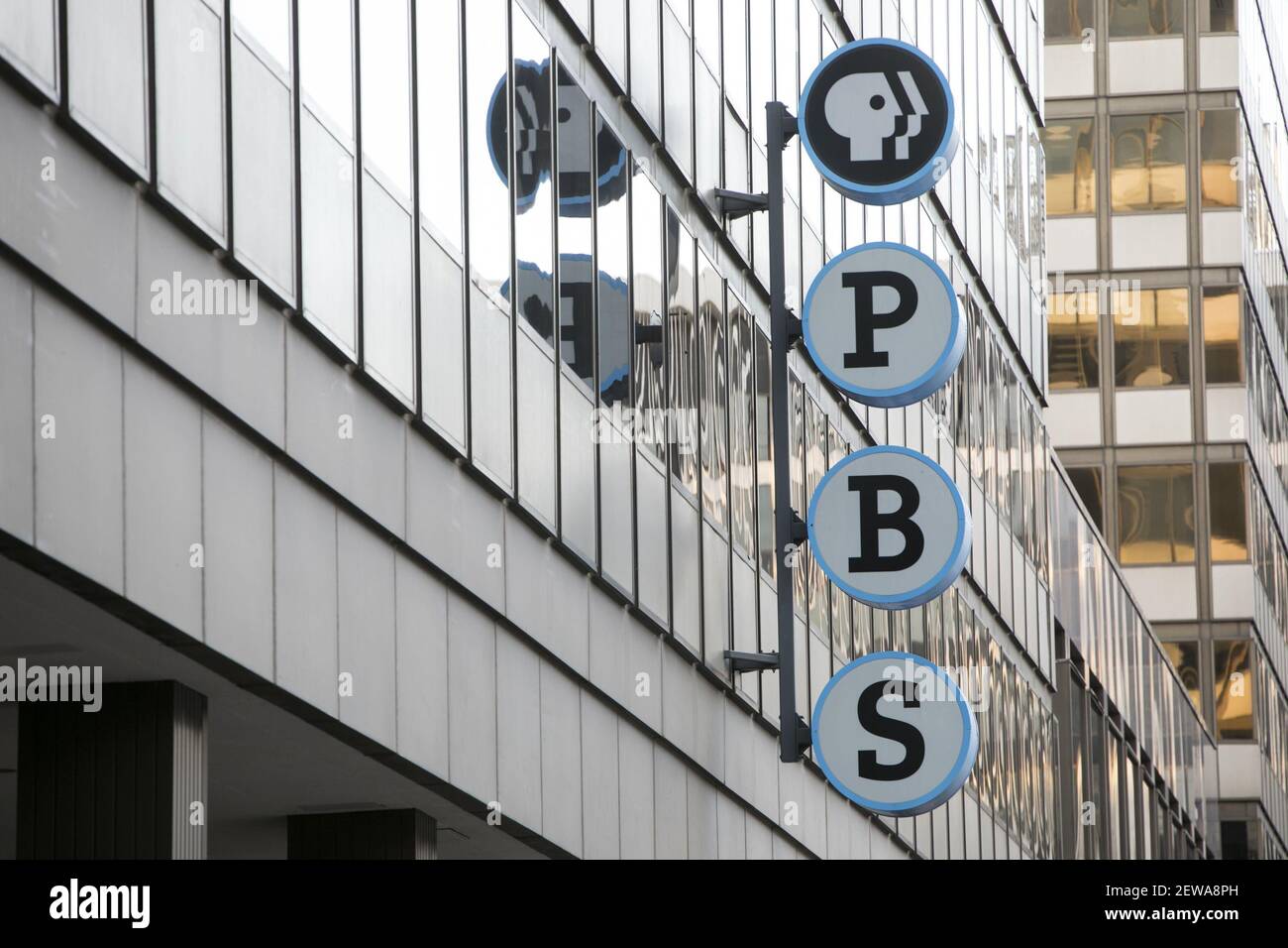 A logo sign outside of the headquarters of The Public Broadcasting ...