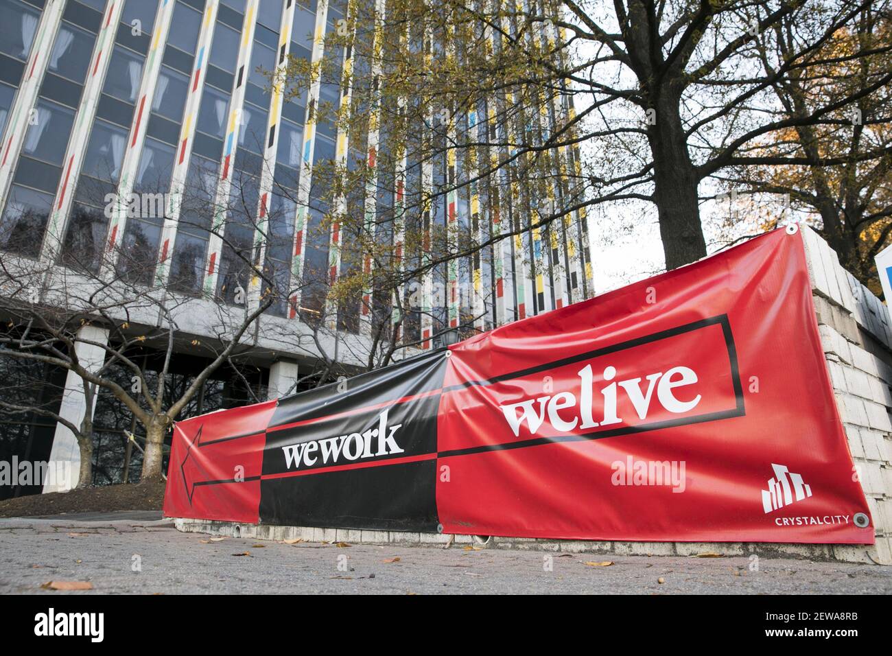 A logo sign outside of a WeWork and WeLive location in Arlington ...