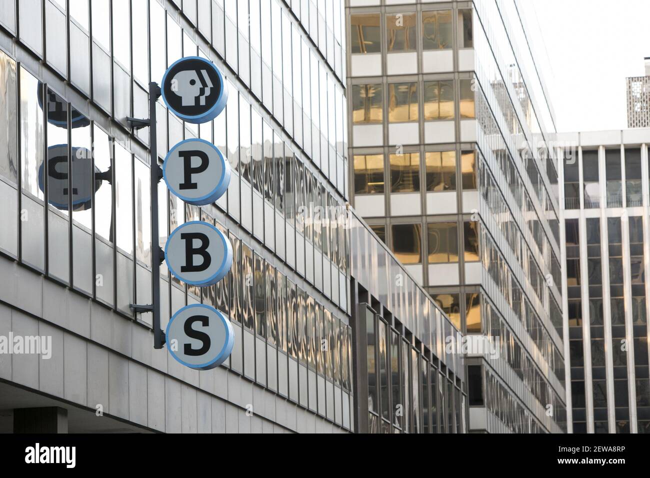 A logo sign outside of the headquarters of The Public Broadcasting ...