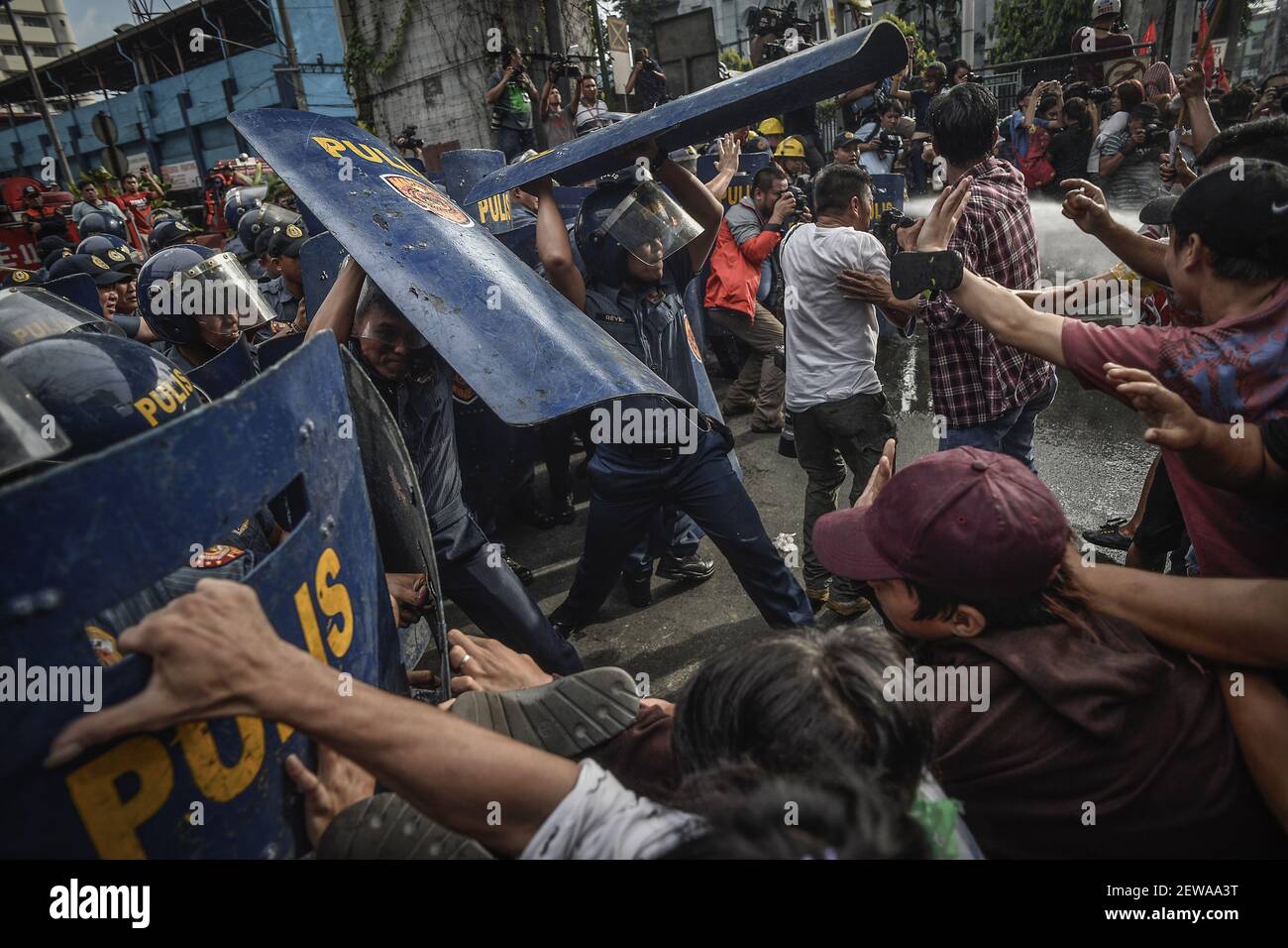 Protesters scuffle with riot police during a demonstration against ...