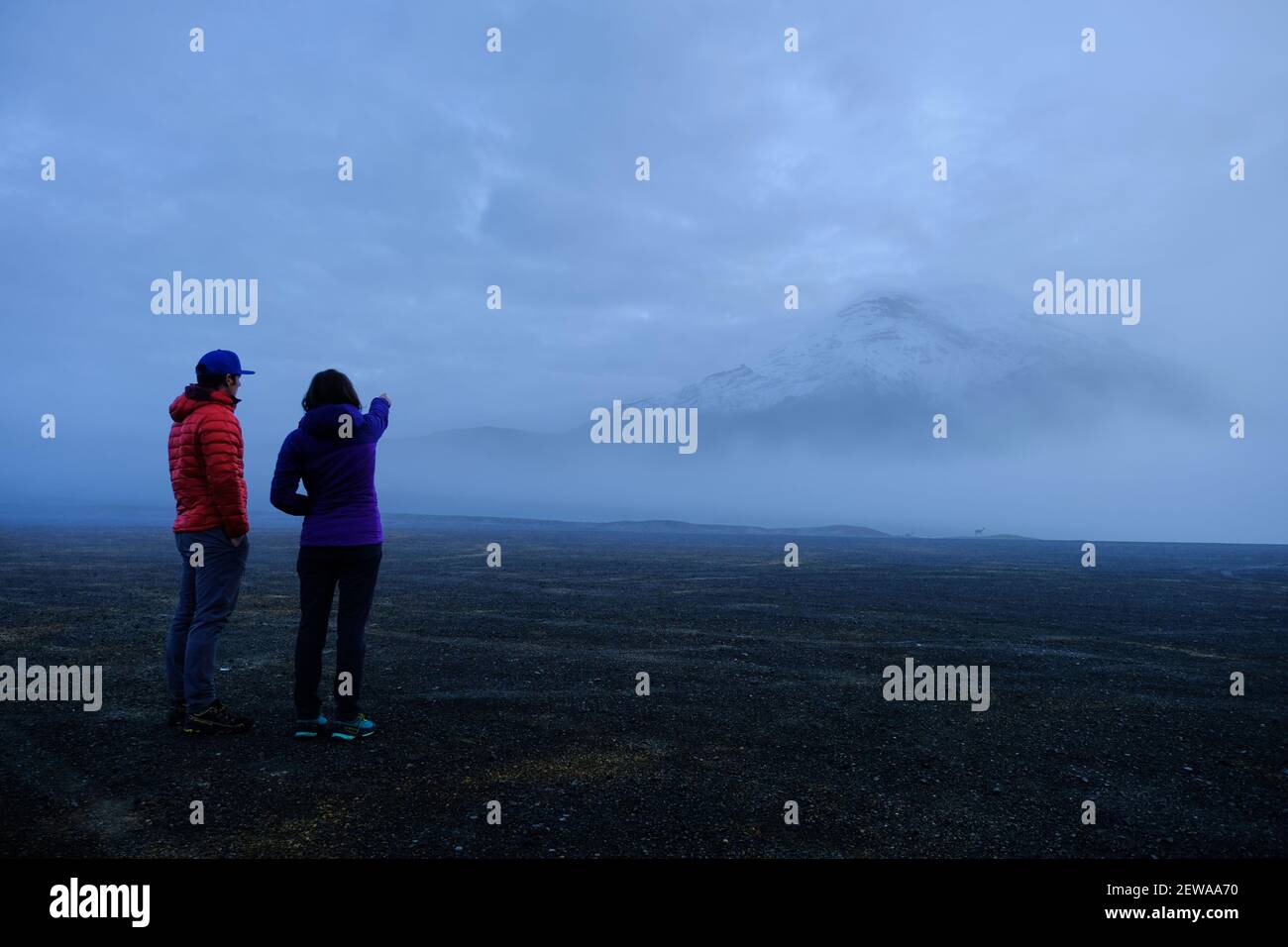 Nate Smith and Dory Trimble watch as fog clears around Chimborazo near ...