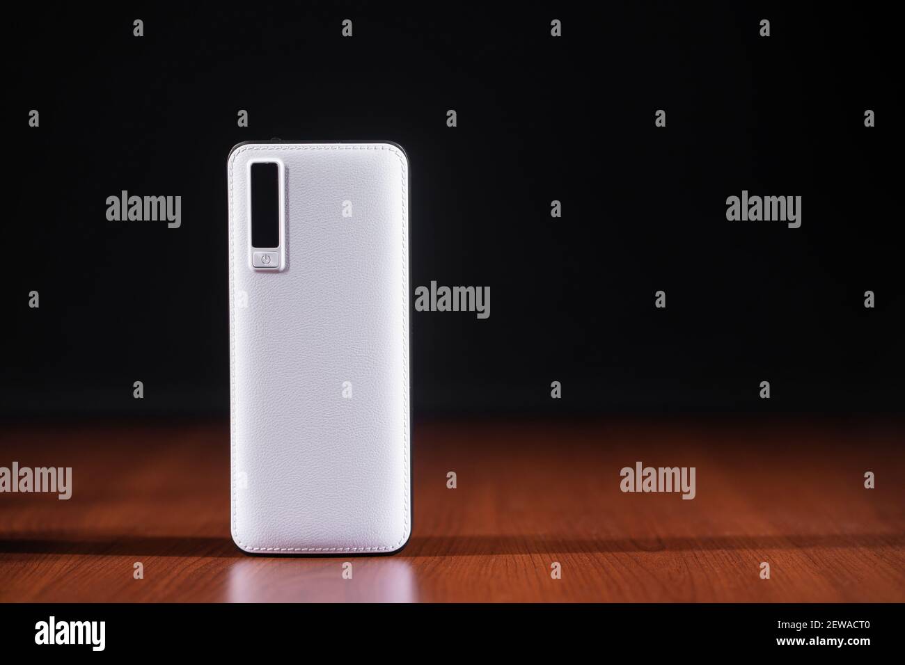 white power bank for charging mobile devices on black background Stock ...