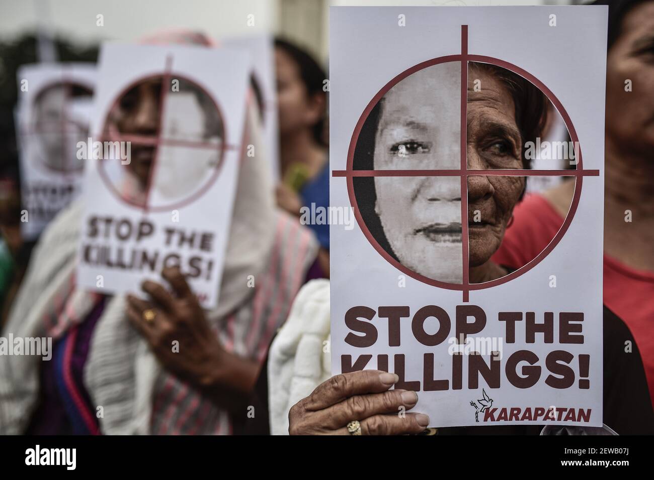 Protesters hold up pictures of victims of extrajudicial killings during ...