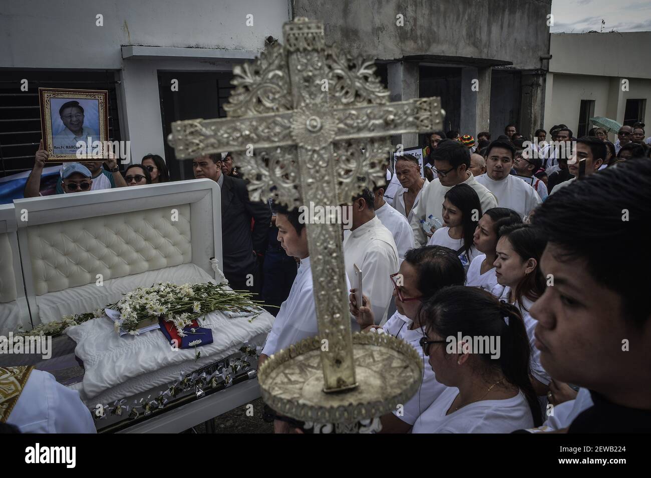 Mourners pay their respects during the funeral of activist priest Fr ...