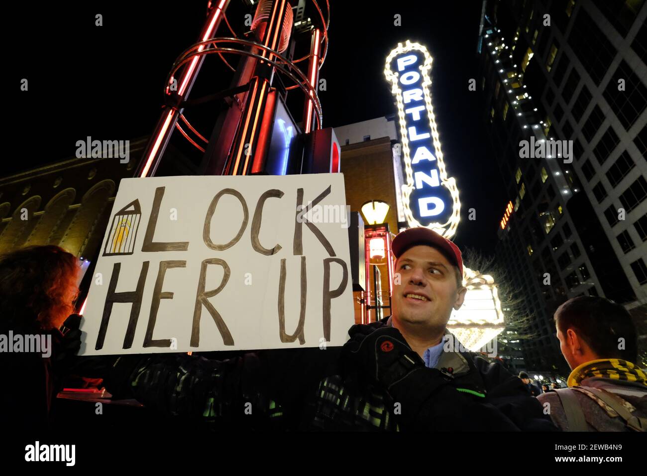 A right-wing Patriot Prayer supporter hold a "Lock Her Up" sign outside ...