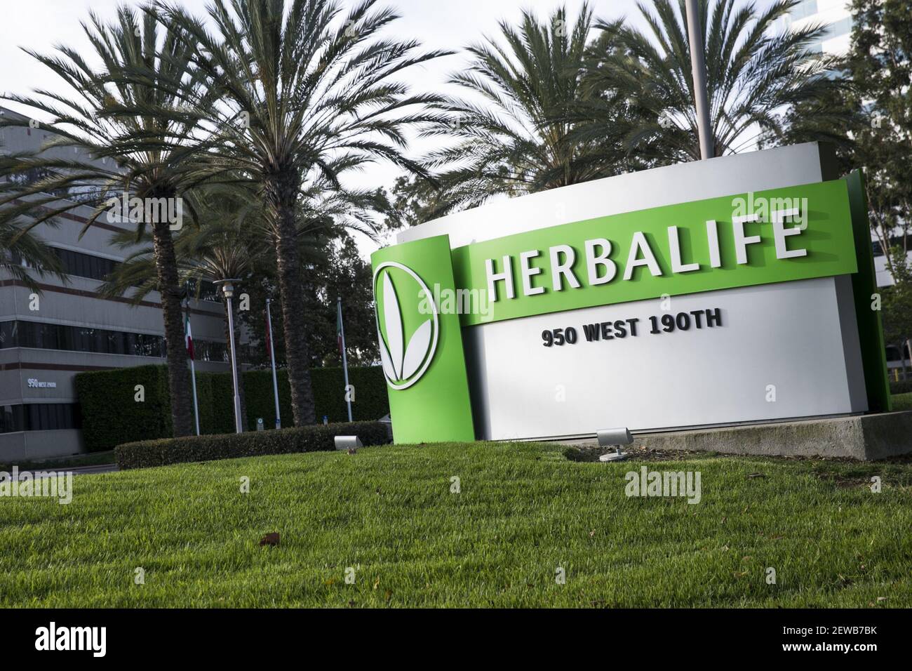 A logo sign outside of a facility occupied by Herbalife International ...