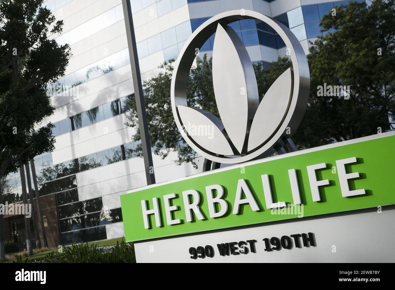 A logo sign outside of a facility occupied by Herbalife International ...