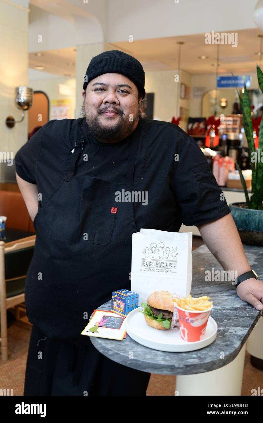 Chef Alvin Cailan's poses with the "Foot Feta-ish" burger, inspired by the animated TV show Bob ...