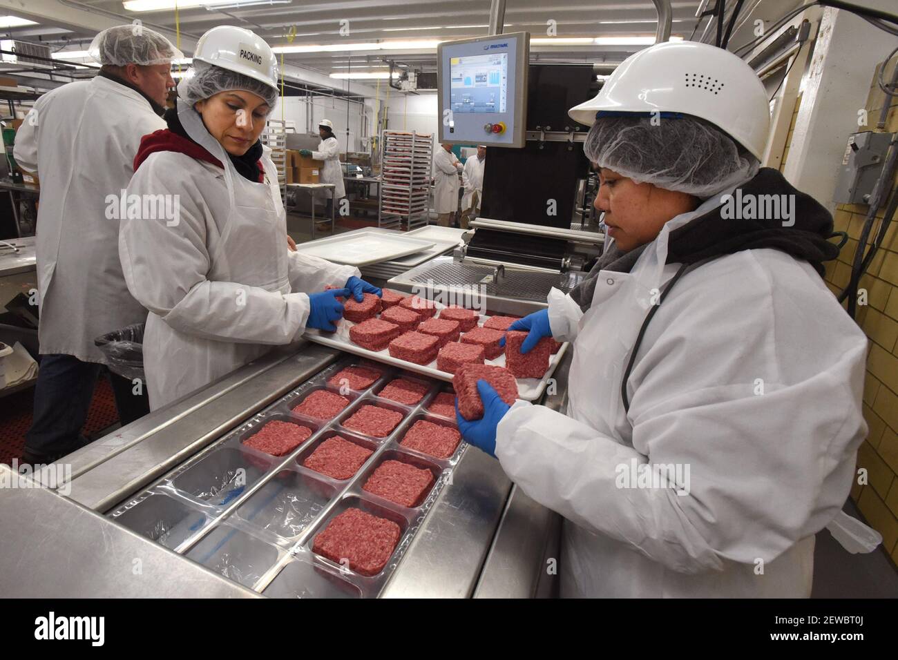 Maria Forest, left, and Alexandra Leiva, right, pack ground beef ...
