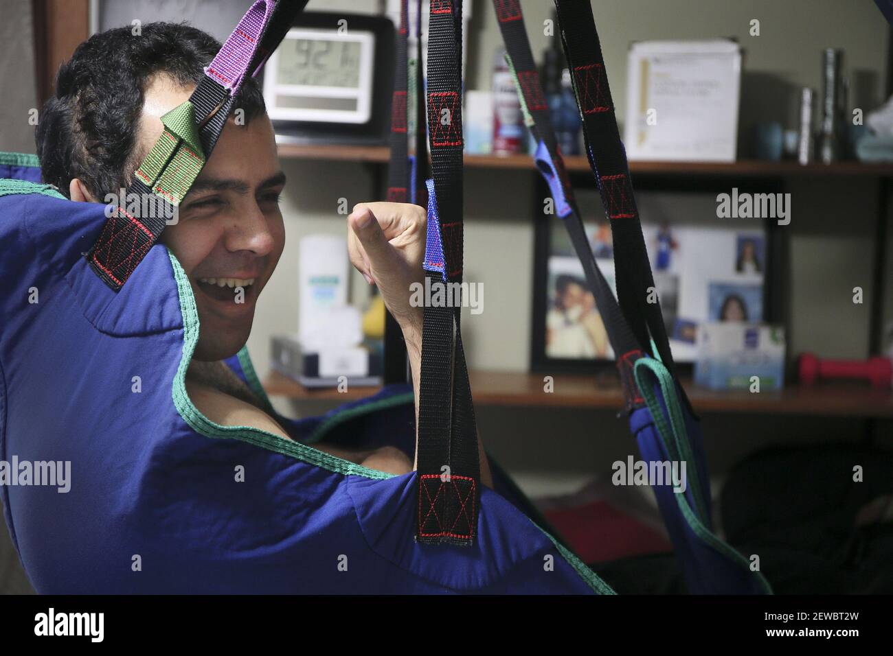 Jose Rodriguez Jr. jokes as he swings from his sling at his home on ...