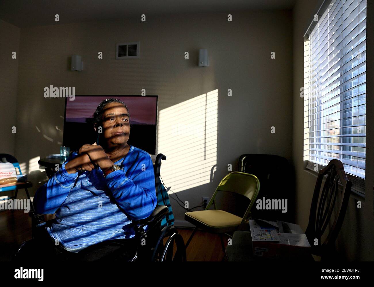 Kathy Nebbitt looks out the window of her new rental home on Corona ...
