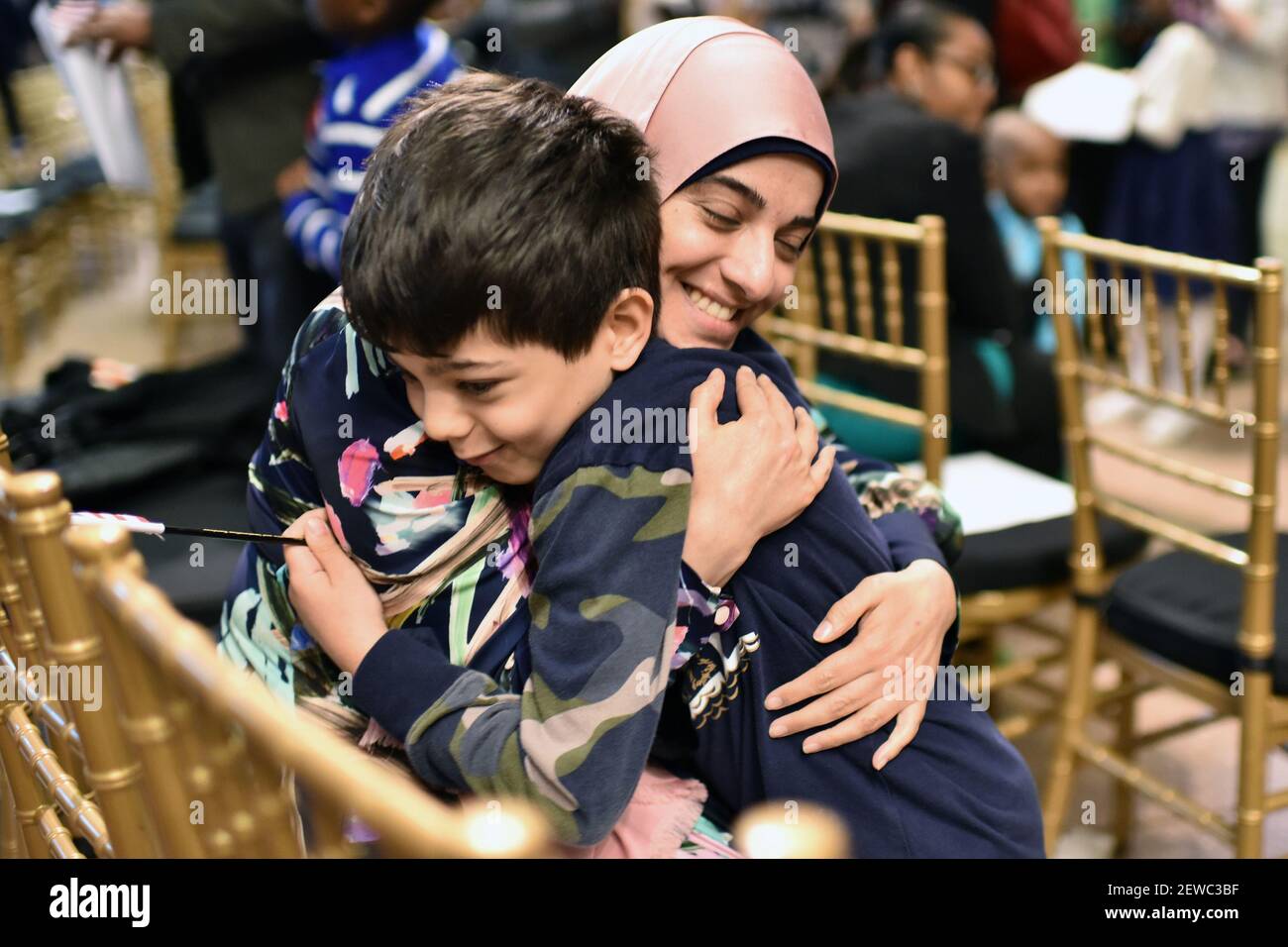 Ali Younes, an 8 year-old from Lebanon, is hugged by his mother after ...