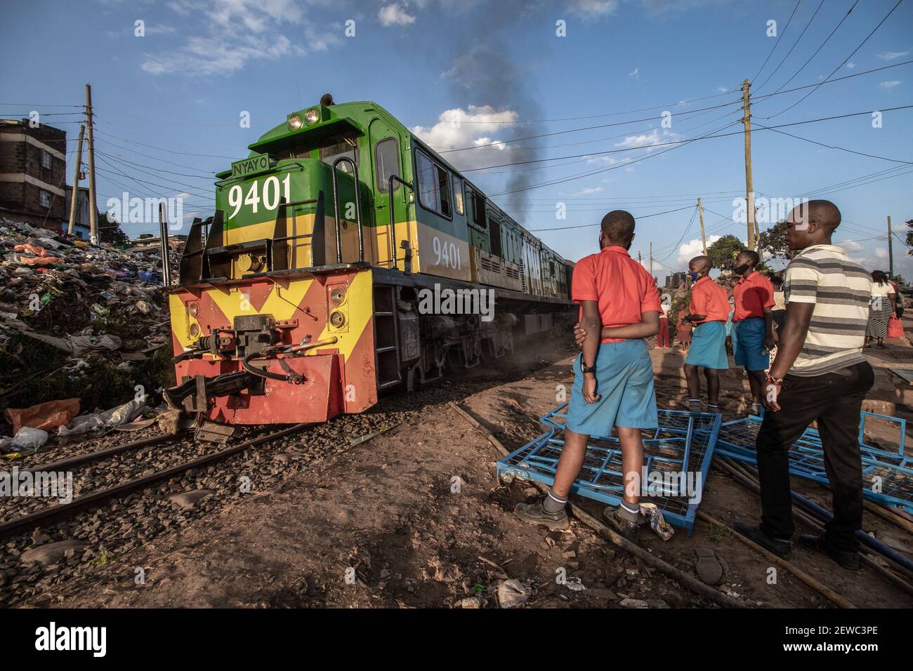 A passengers train seen on its way past the busy streets during the ...