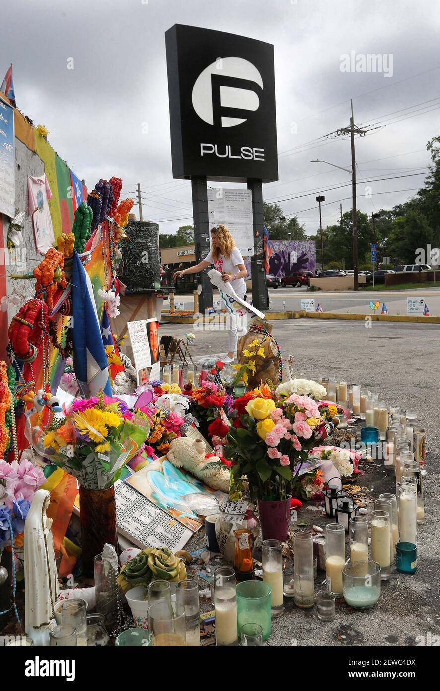 Pulse nightclub owner Barbara Poma tends to the memorial in front of ...