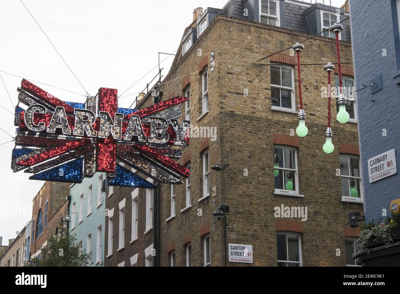 English flag Carnaby sign in front of the old buildings, Carnaby Street ...