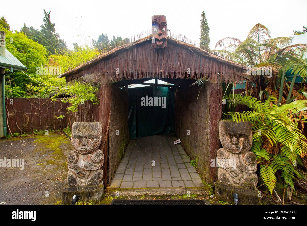 Traditional Maori structure with carvings at the Mitai Maori Village ...