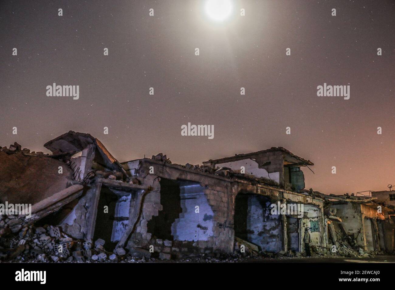 Comet Neowise is observed over the sky through a destroyed building in ...