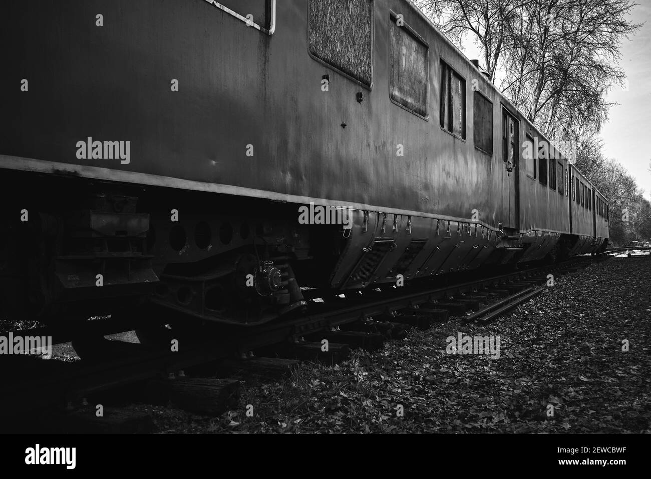 A grayscale shot of a passenger train on the tracks Stock Photo - Alamy