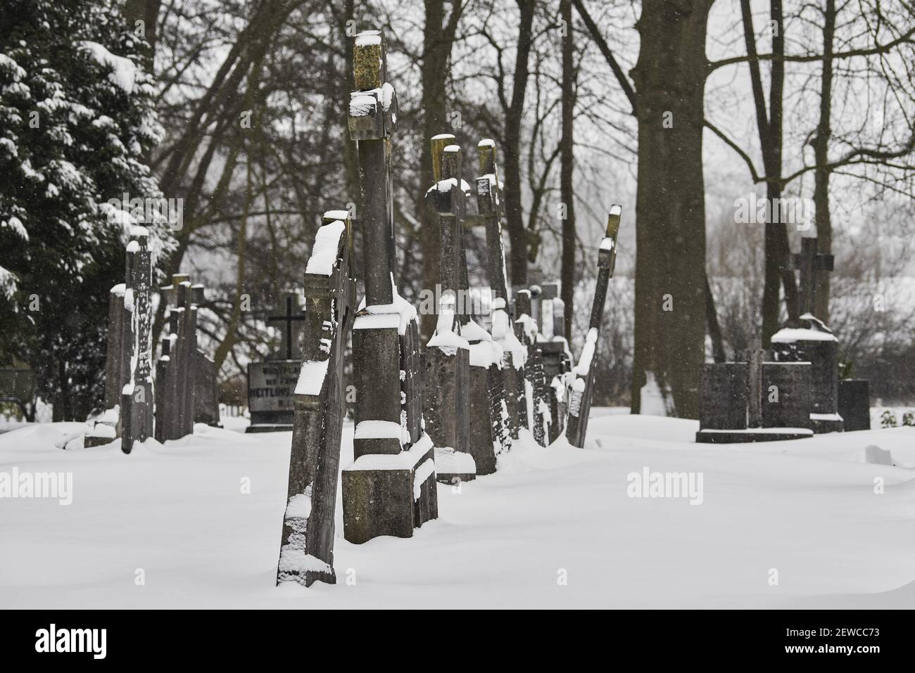 A selective focus shot of a snow-covered graveyard Stock Photo - Alamy