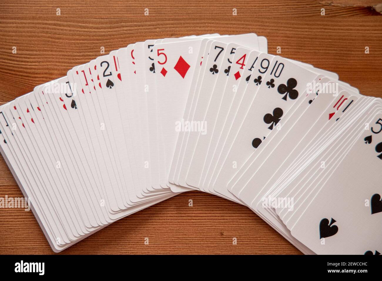 A closeup shot of playing cards on a wooden surface Stock Photo - Alamy