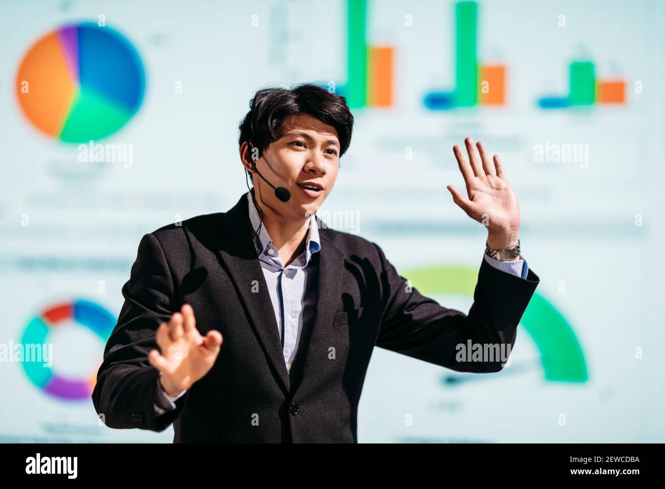 Male Asian Speaker Stands on Stage for Business Presentation Stock ...