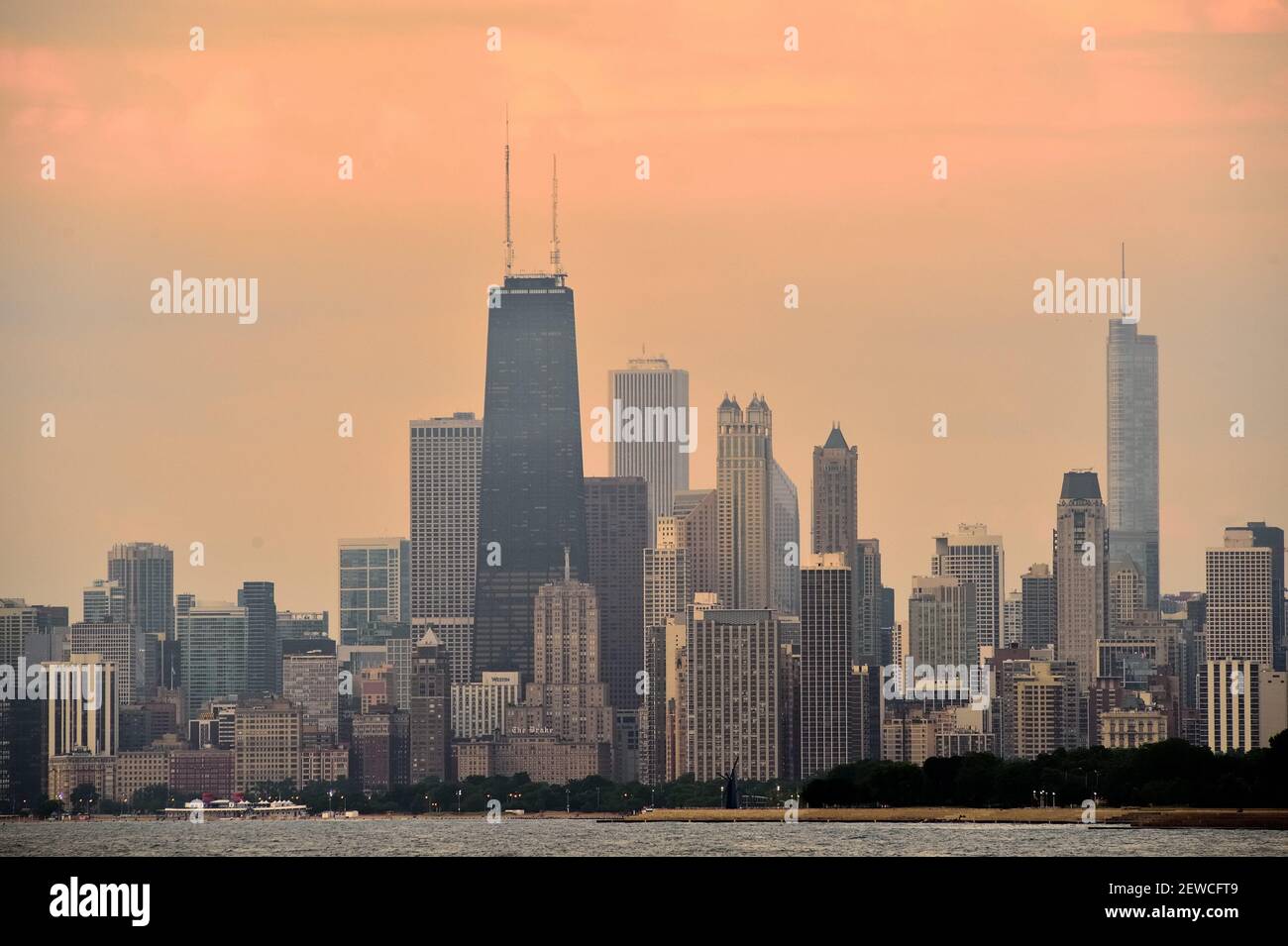 Chicago, Illinois, USA. A muted sunrise casts light into the clouds ...