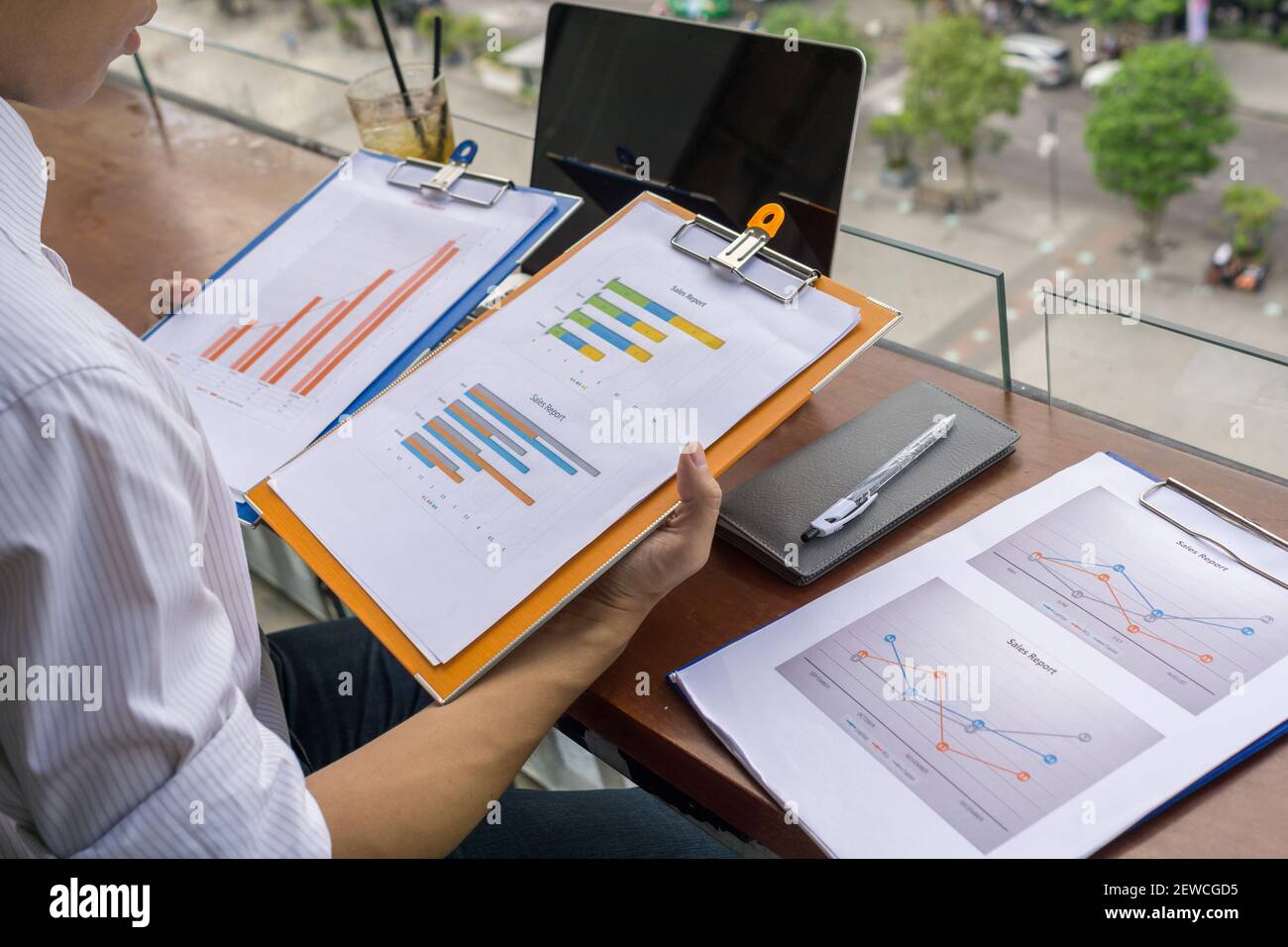 Young investor reading financial report outdoor the balcony Stock Photo ... Young investor reading financial report outdoor the balcony Stock Photo ...