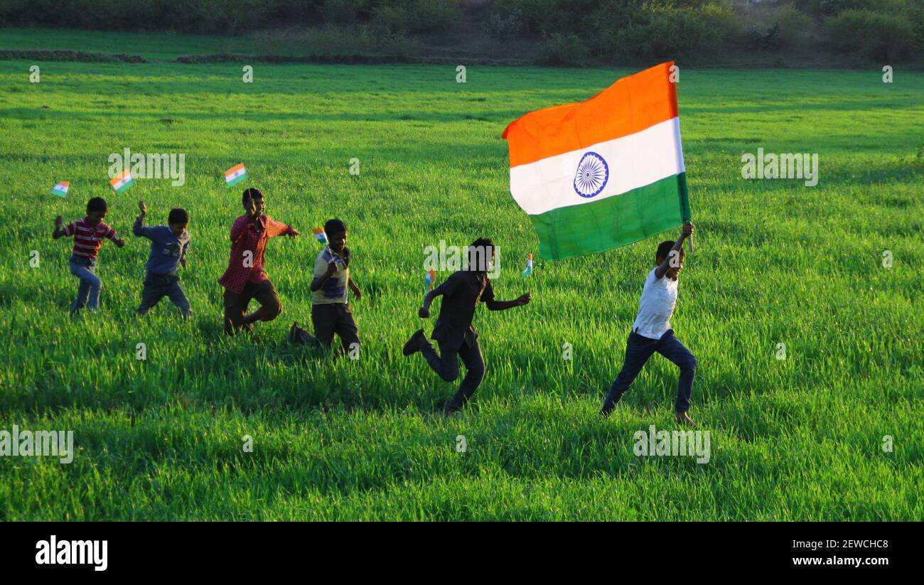 Indian children run with the national tricolor (Tiranga) flags in the ...