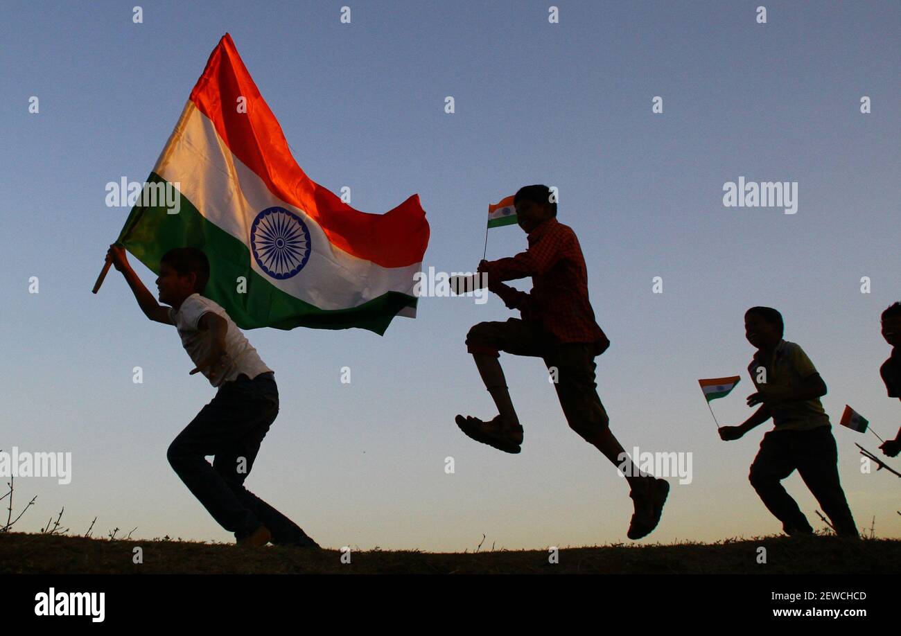 Indian children run with the national tricolor (Tiranga) flags in the ...