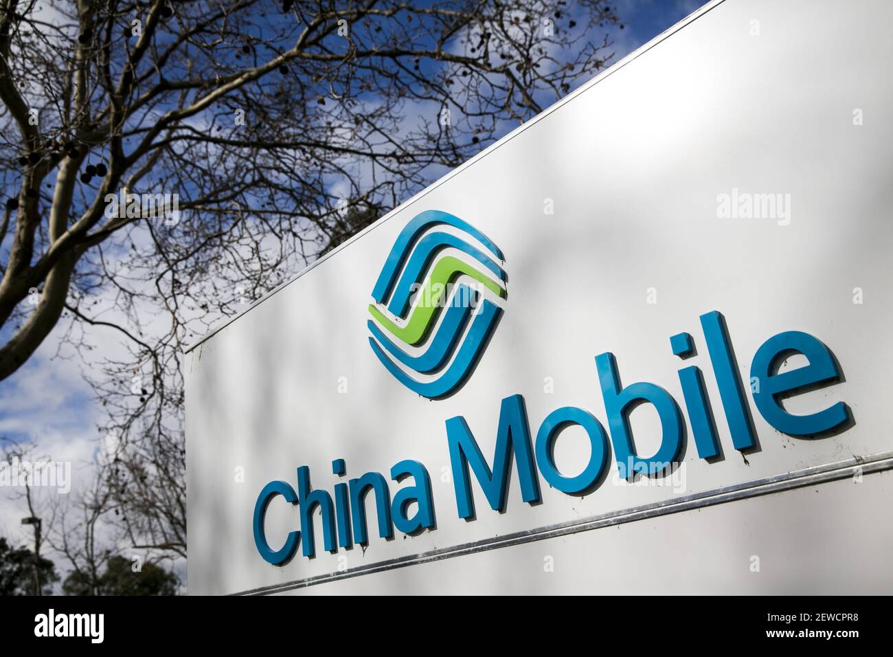 A logo sign outside of a facility occupied by Chine Mobile in Milpitas ...