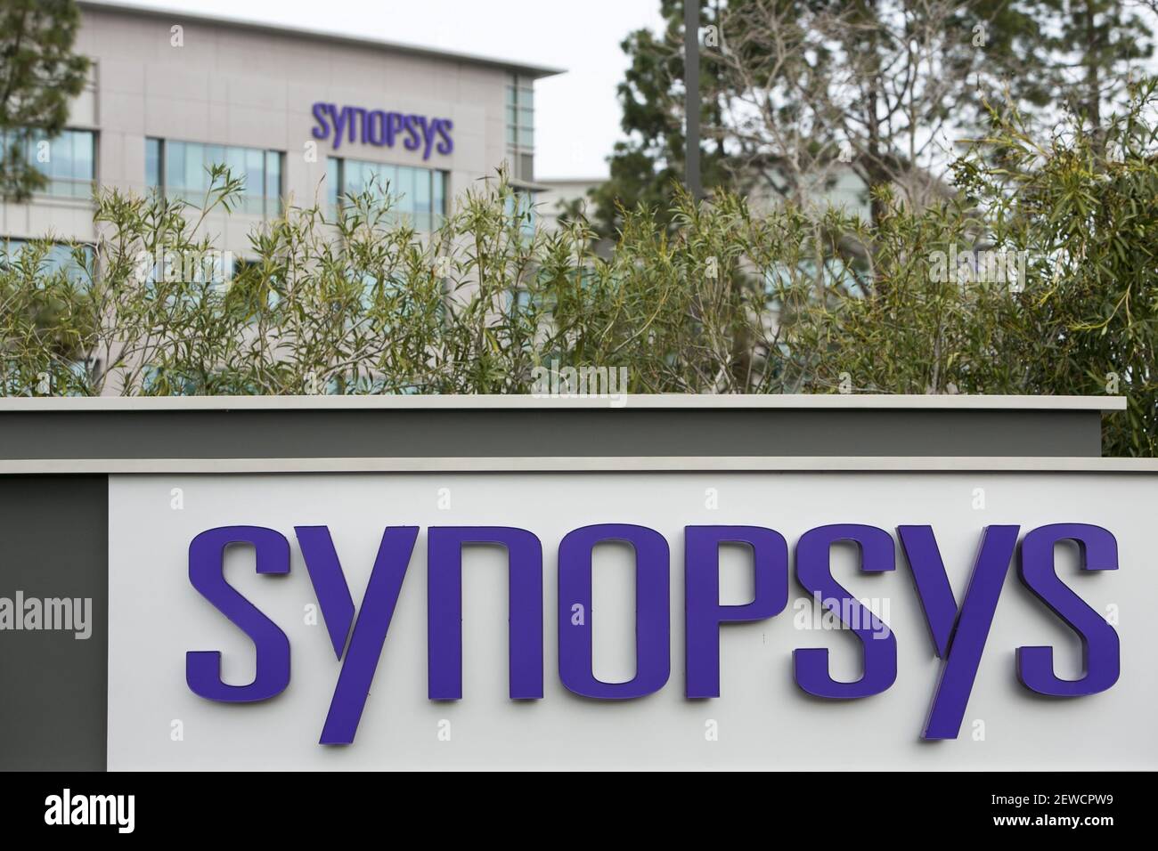 A logo sign outside of the headquarters of Synopsys, Inc., in Mountain ...