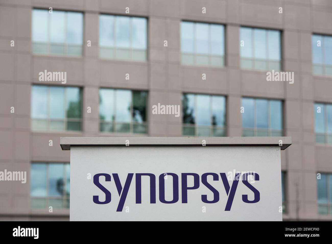 A logo sign outside of the headquarters of Synopsys, Inc., in Mountain ...