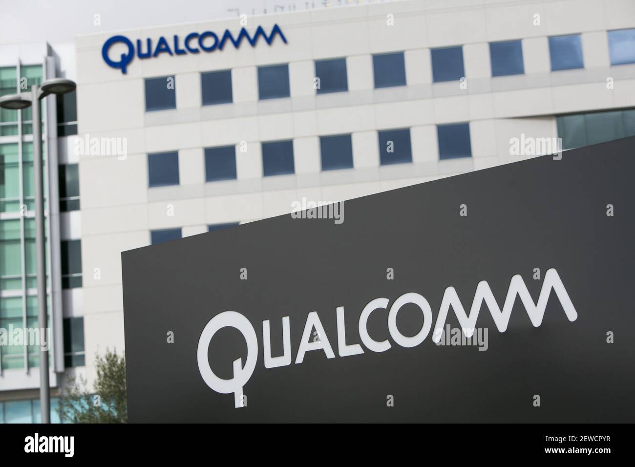 A logo sign outside of a facility occupied by Qualcomm in San Diego ...