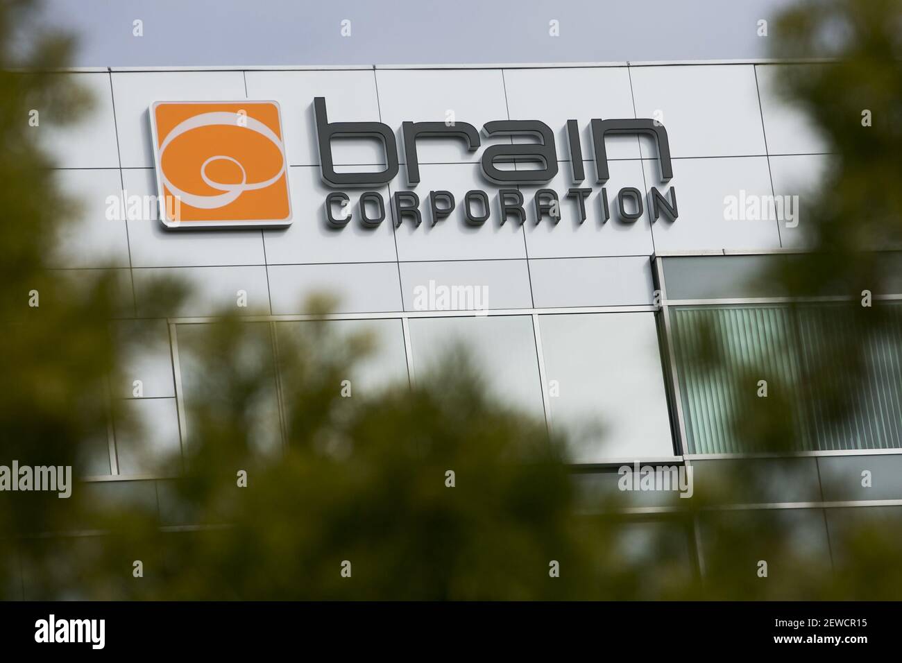 A logo sign outside of the headquarters of the Brain Corporation in San ...