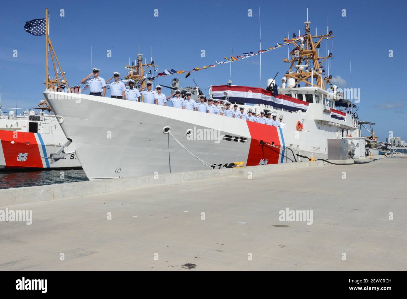 The crew of the Coast Guard Cutter Joseph Napier salute during the ...