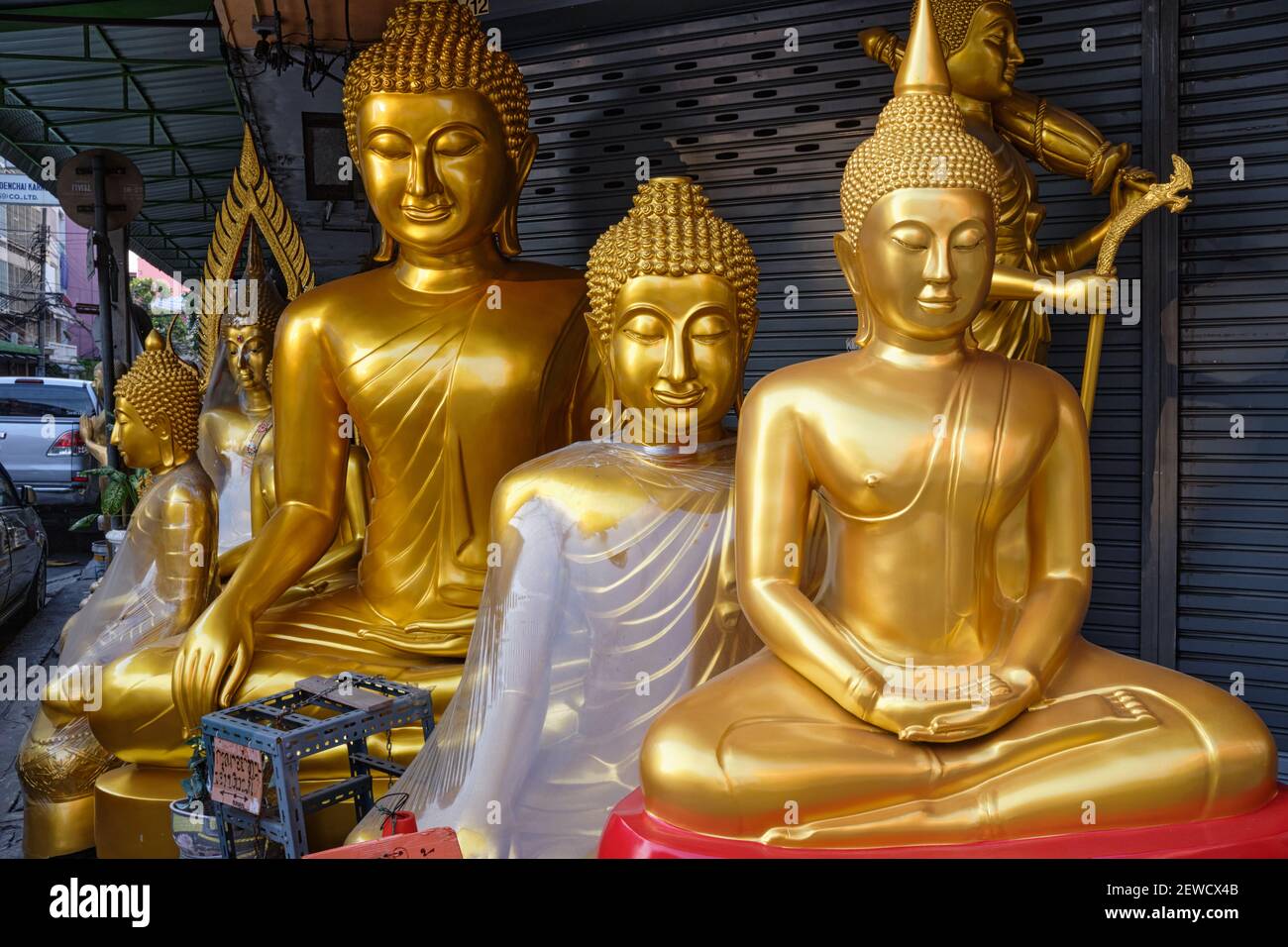 Buddha statues stand outside a factory-cum-shop for religious objects ...