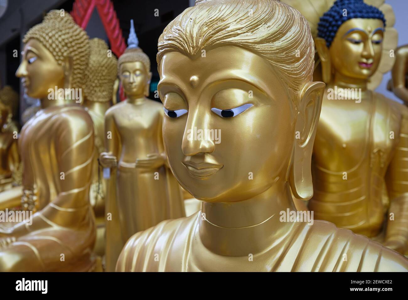 Buddha statues stand outside a factory-cum-shop for religious objects ...