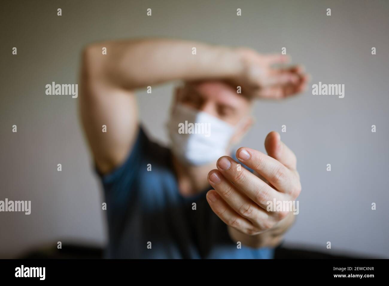 bald man in medical mask pulling his hands forward, concept of pleading ...
